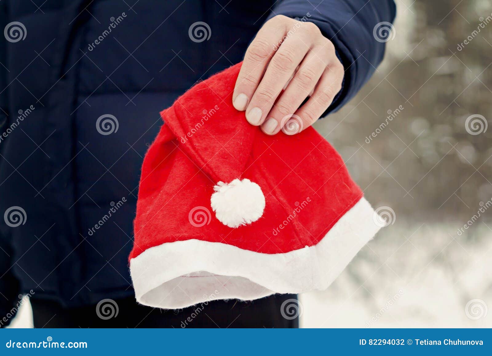 Man`s Hand Holding a Santa Claus Hat Close Up Stock Photo - Image of ...