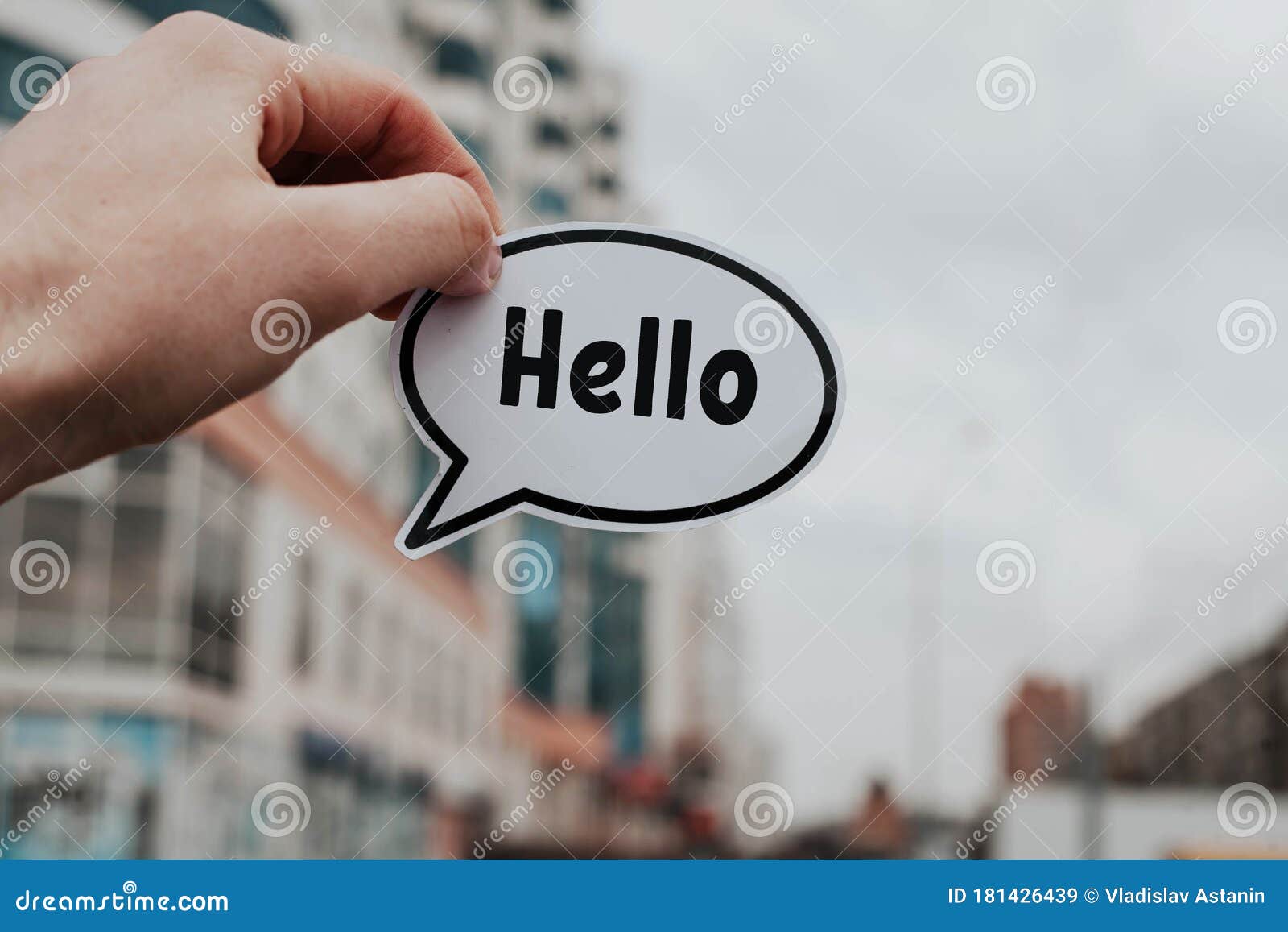 A Man`s Hand Holds a Piece of Paper with the Inscription Hello Stock ...