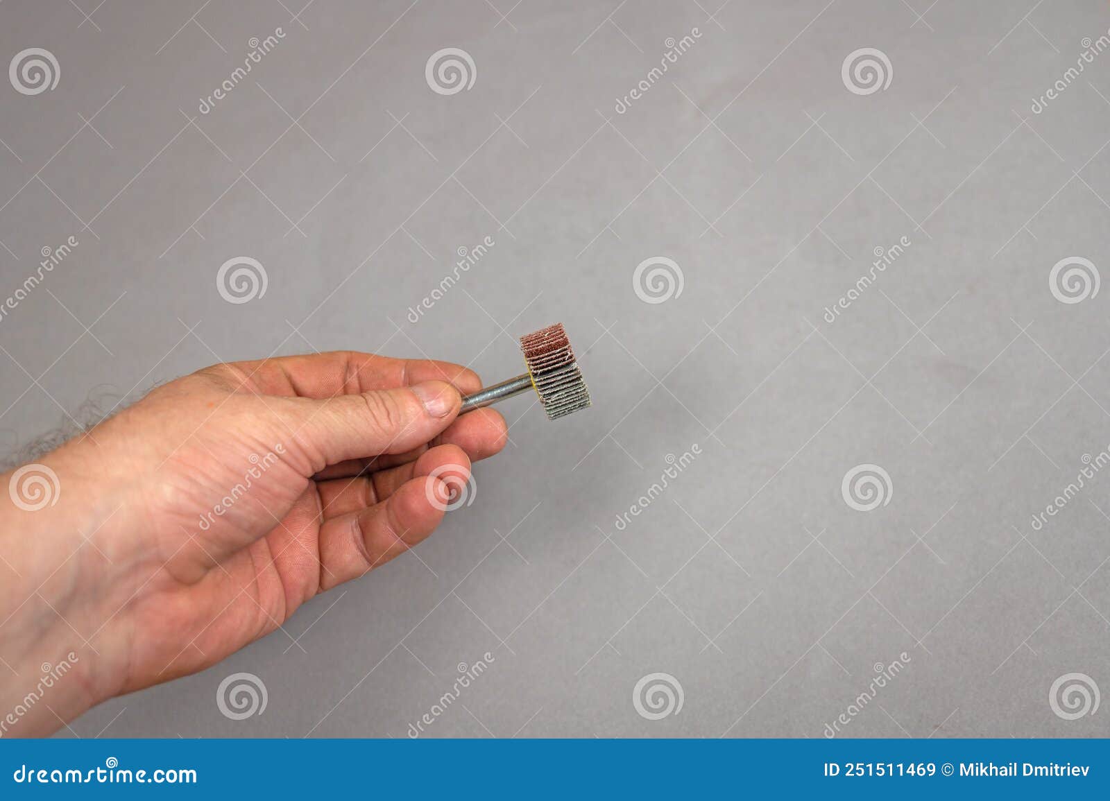 A Man`s Hand Holds the Sanding Blade Wheel. a Tool for Woodworking As ...