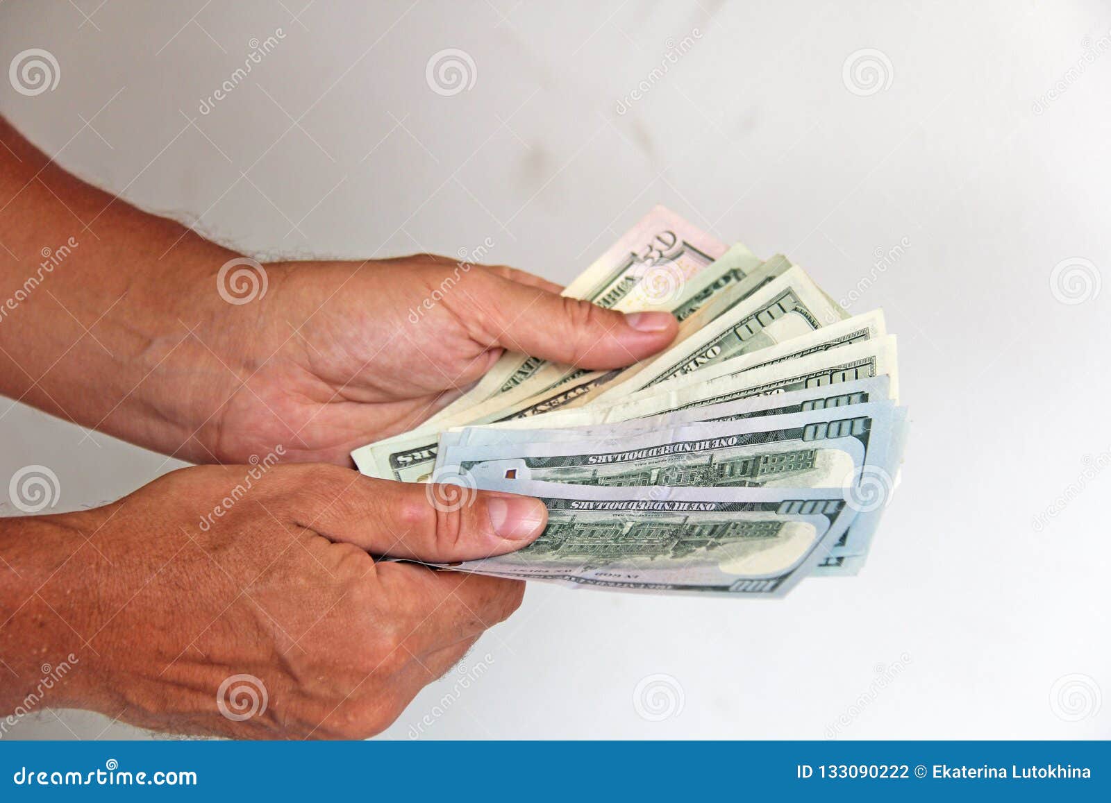 The Man`s Hand Holds Us Dollars Counts Them And Pays Paper Mon Stock