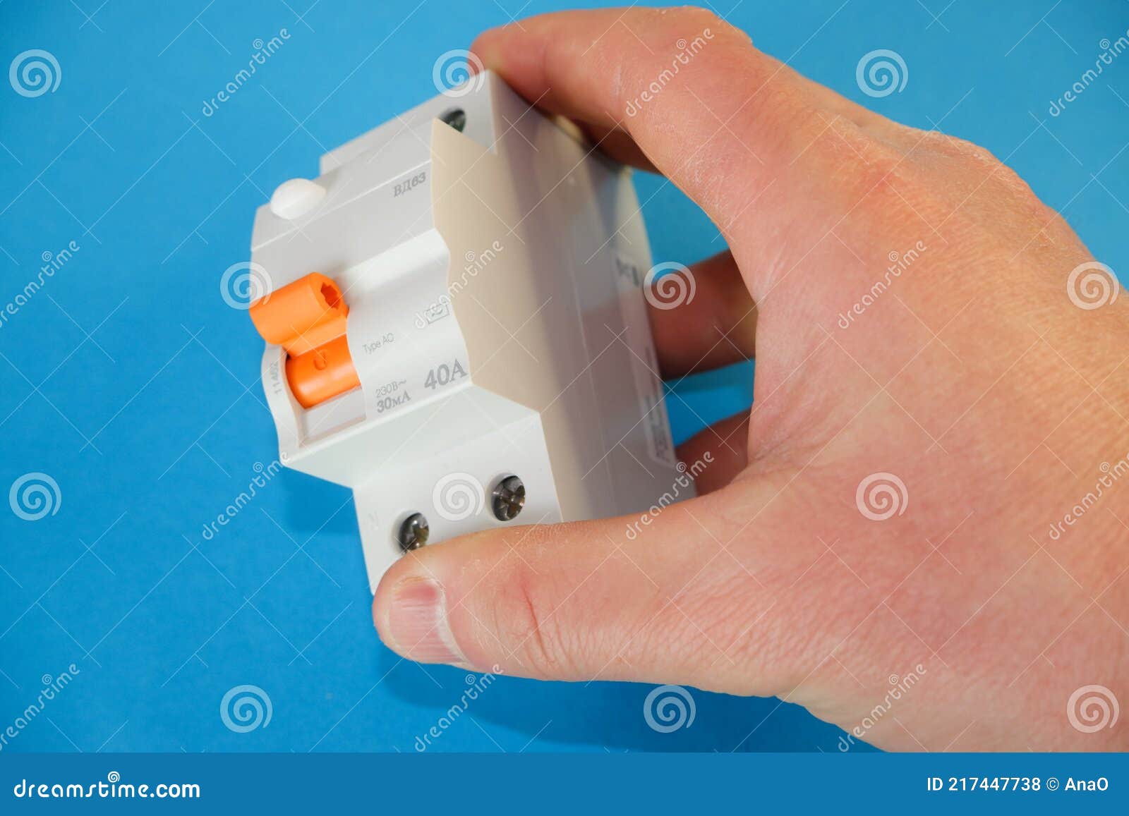 A Man`s Hand Holds a White, Automatic Differential Current Switch. Blue ...