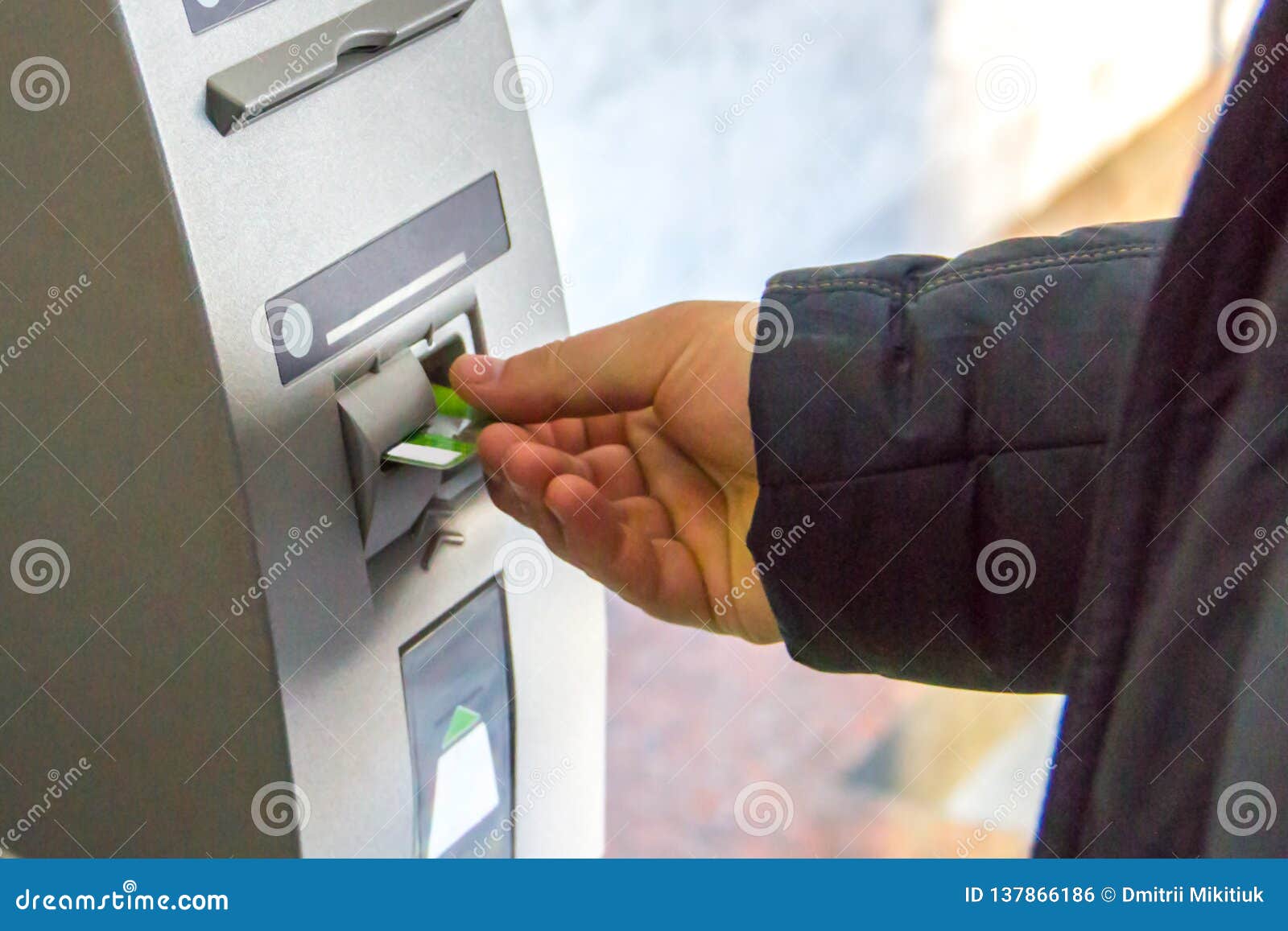 A Man`s Hand Inserts a Plastic Card into the Card Receptacle of Cash ...