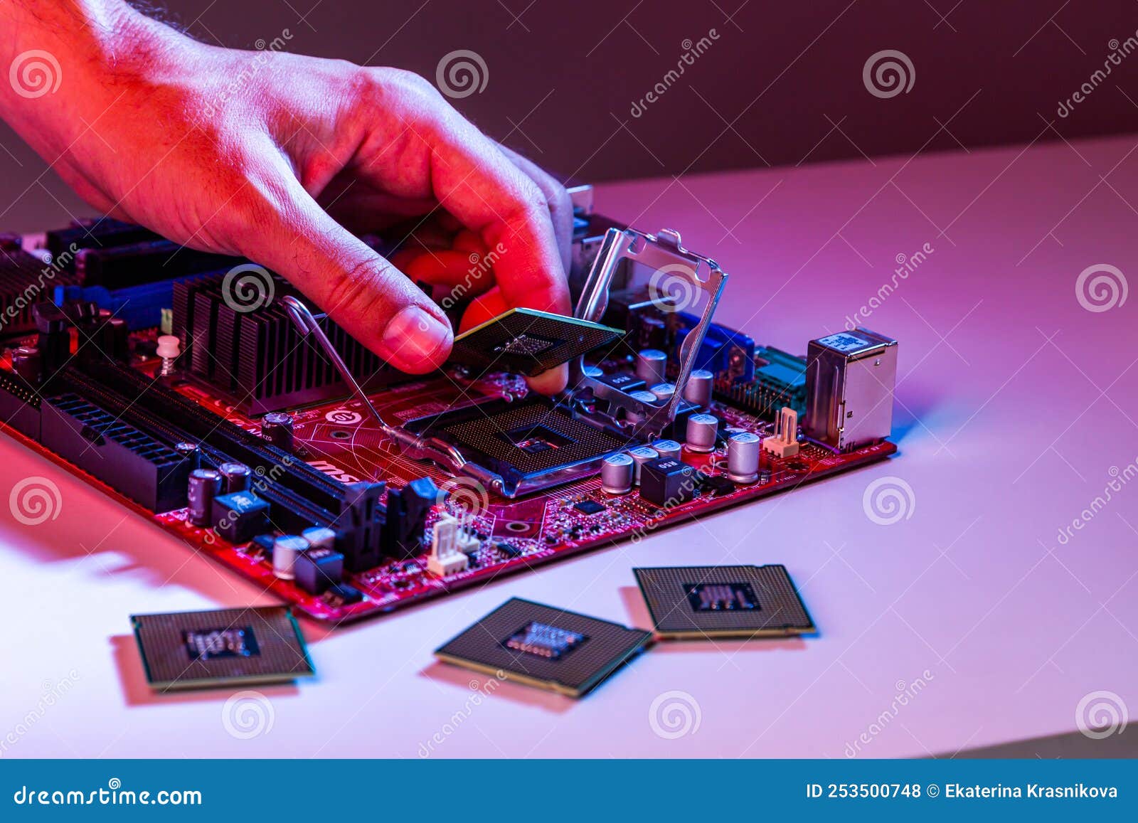A Man`s Hand Inserts a Processor into the Motherboard Chipset Stock ...