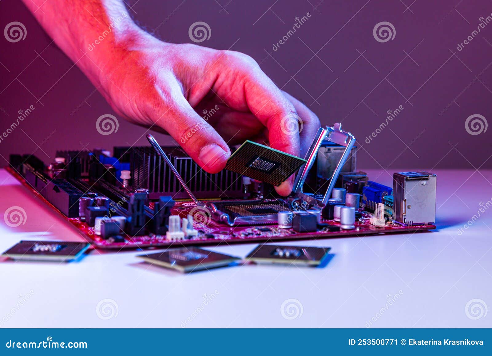A Man`s Hand Inserts a Processor into the Motherboard Chipset Stock ...