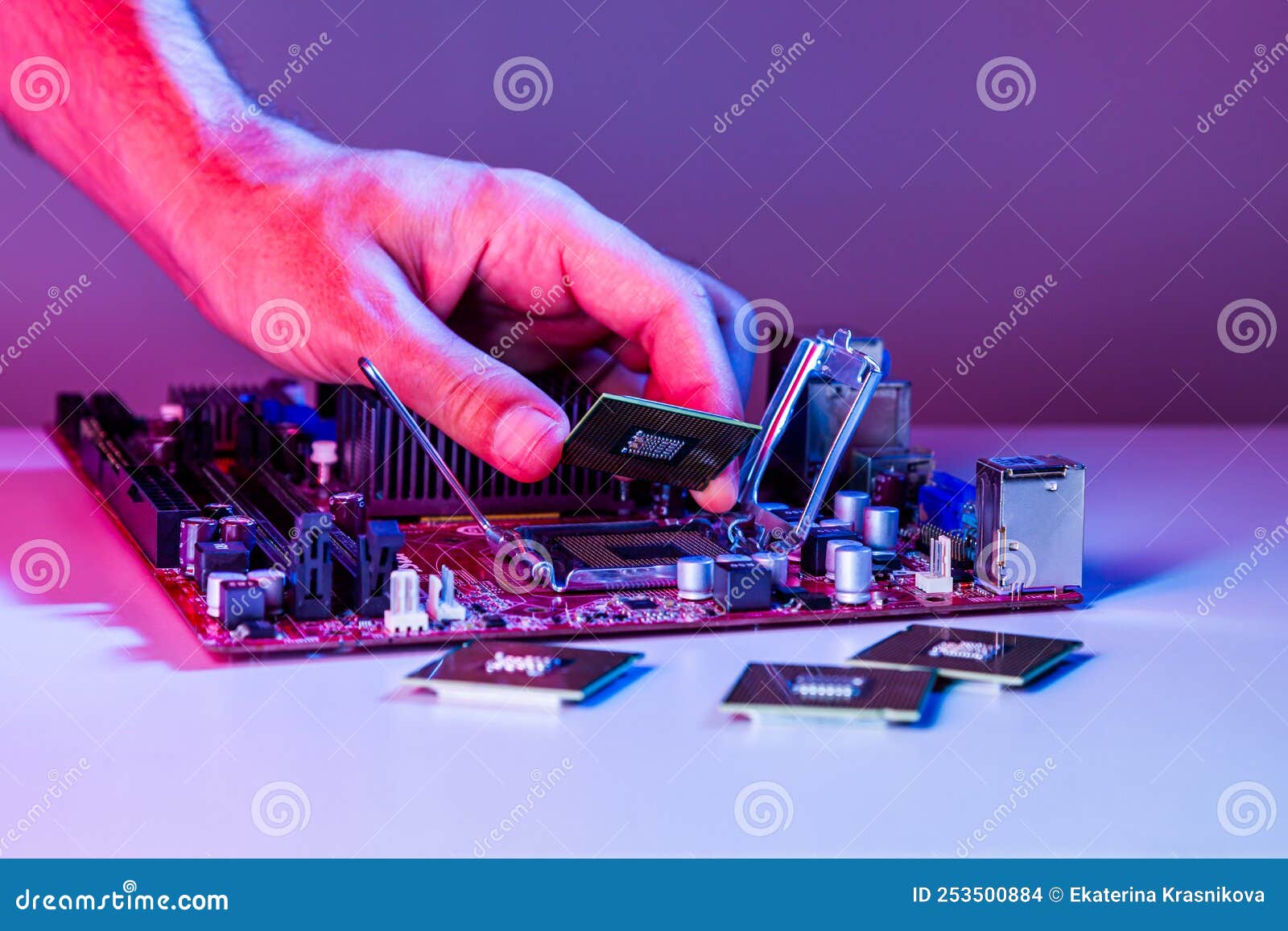 A Man`s Hand Inserts a Processor into the Motherboard Chipset Stock ...