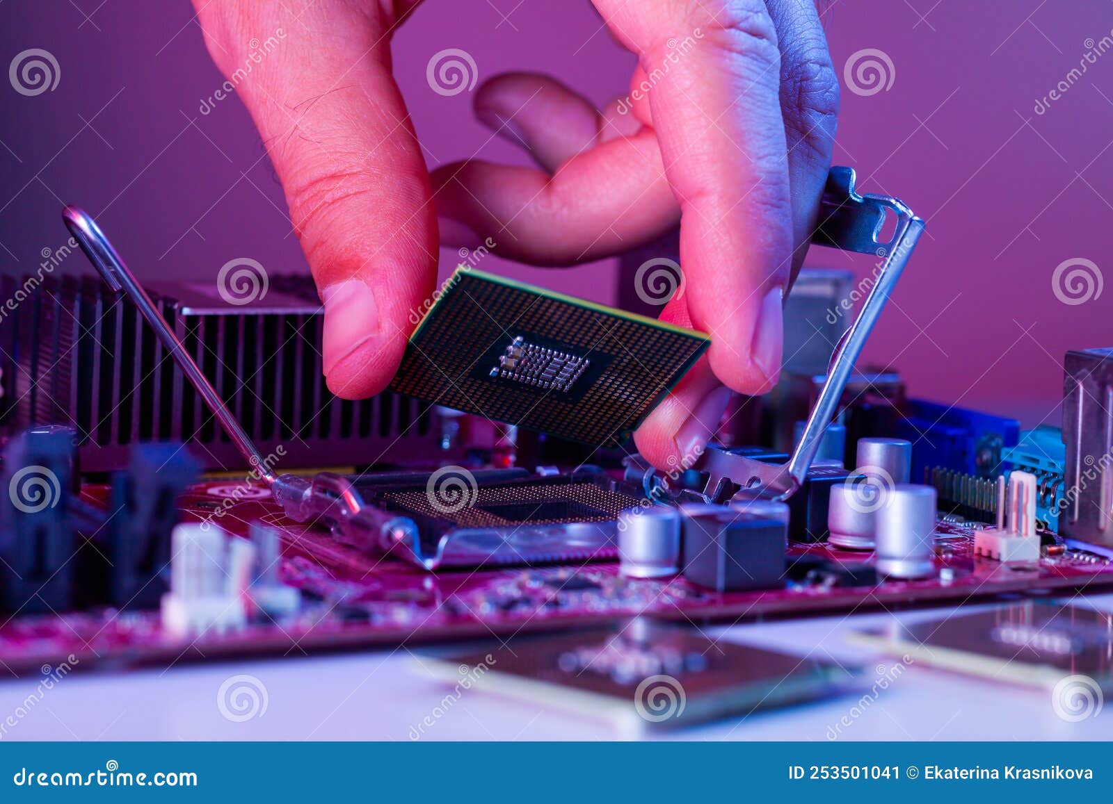 A Man`s Hand Inserts a Processor into the Motherboard Chipset Stock ...