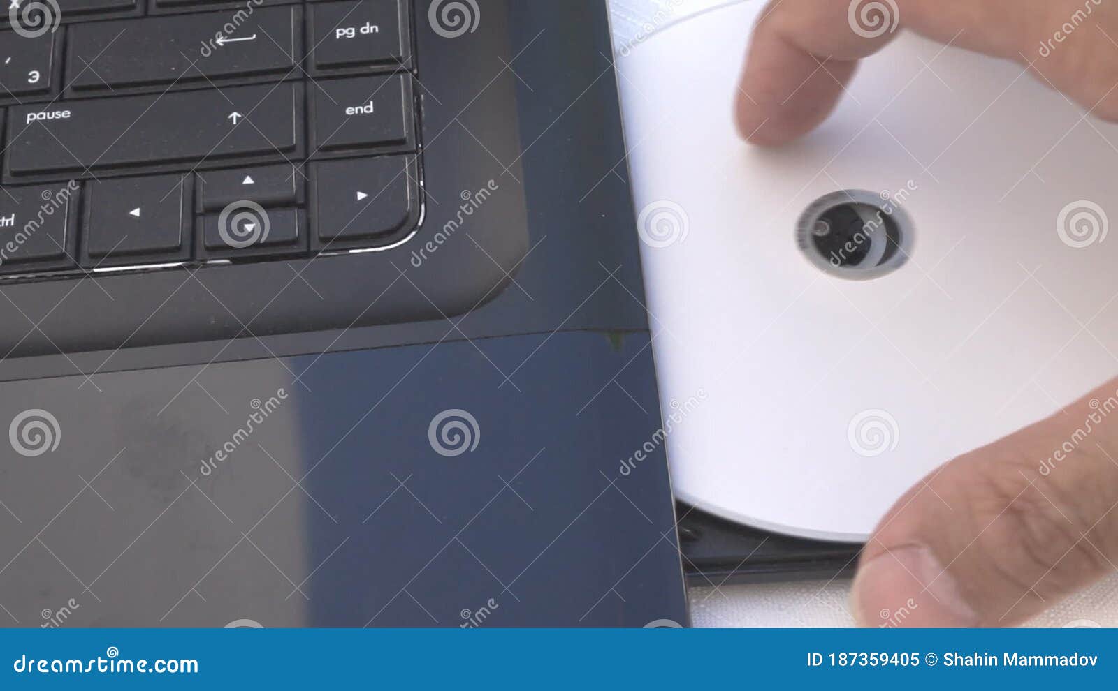 A Man S Hand Opens the Computer S Drive and Inserts the Disk. Stock ...