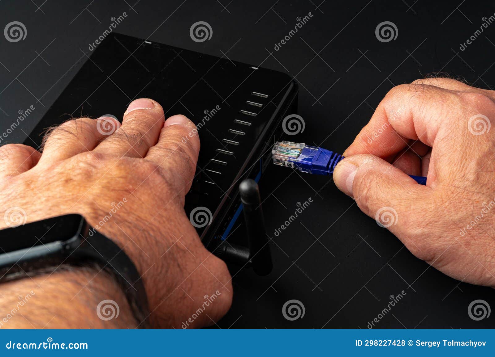 Man& X27;s Hand Plugging Internet Cable into Wifi Router Stock Photo ...