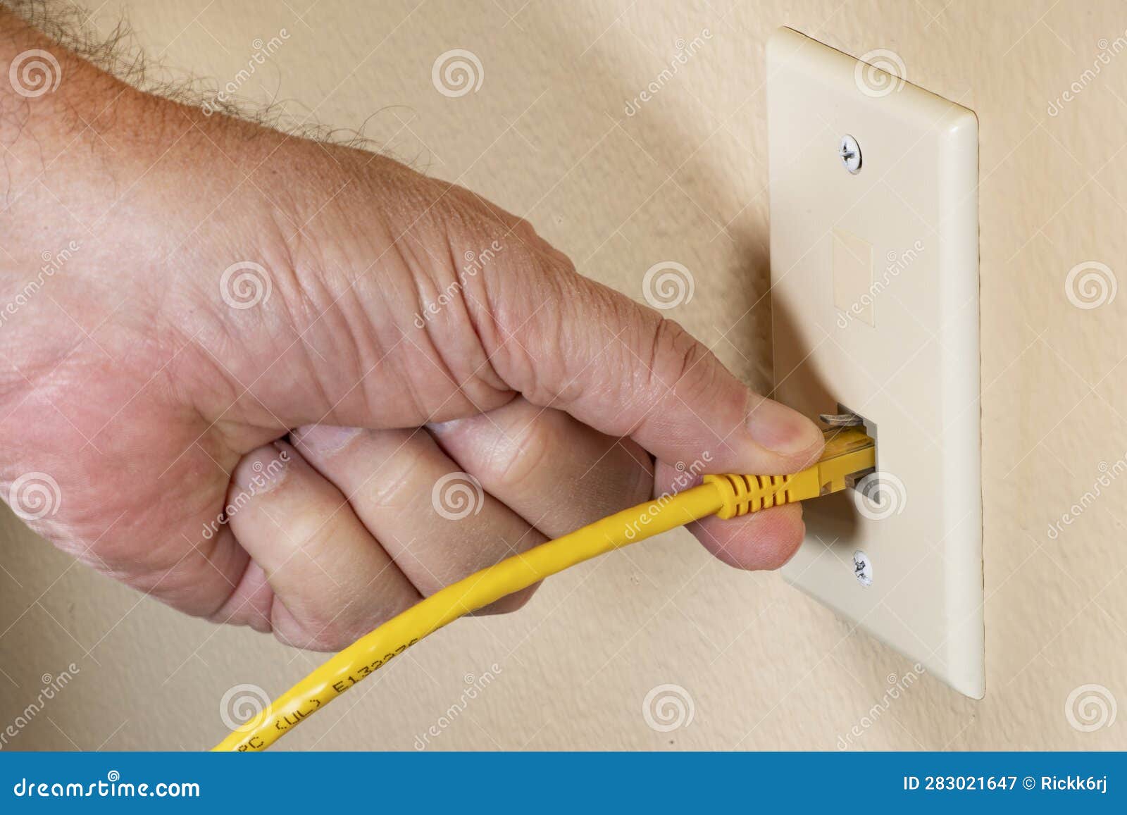 Man& X27;s Hand Plugging Yellow Ethernet Cable RJ45 into Home Network ...
