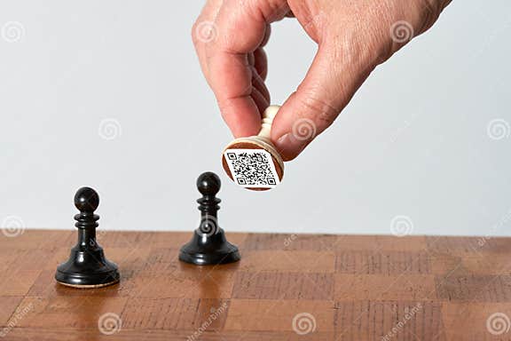 A Man`s Hand Rearranges a Chess Piece with a QR Code on the Chessboard ...