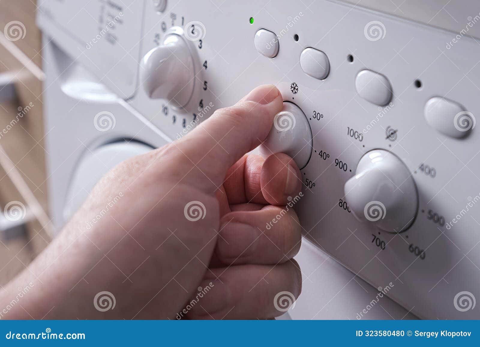 A Man S Hand Sets the Washing Mode Temperature Switch on the Washing ...