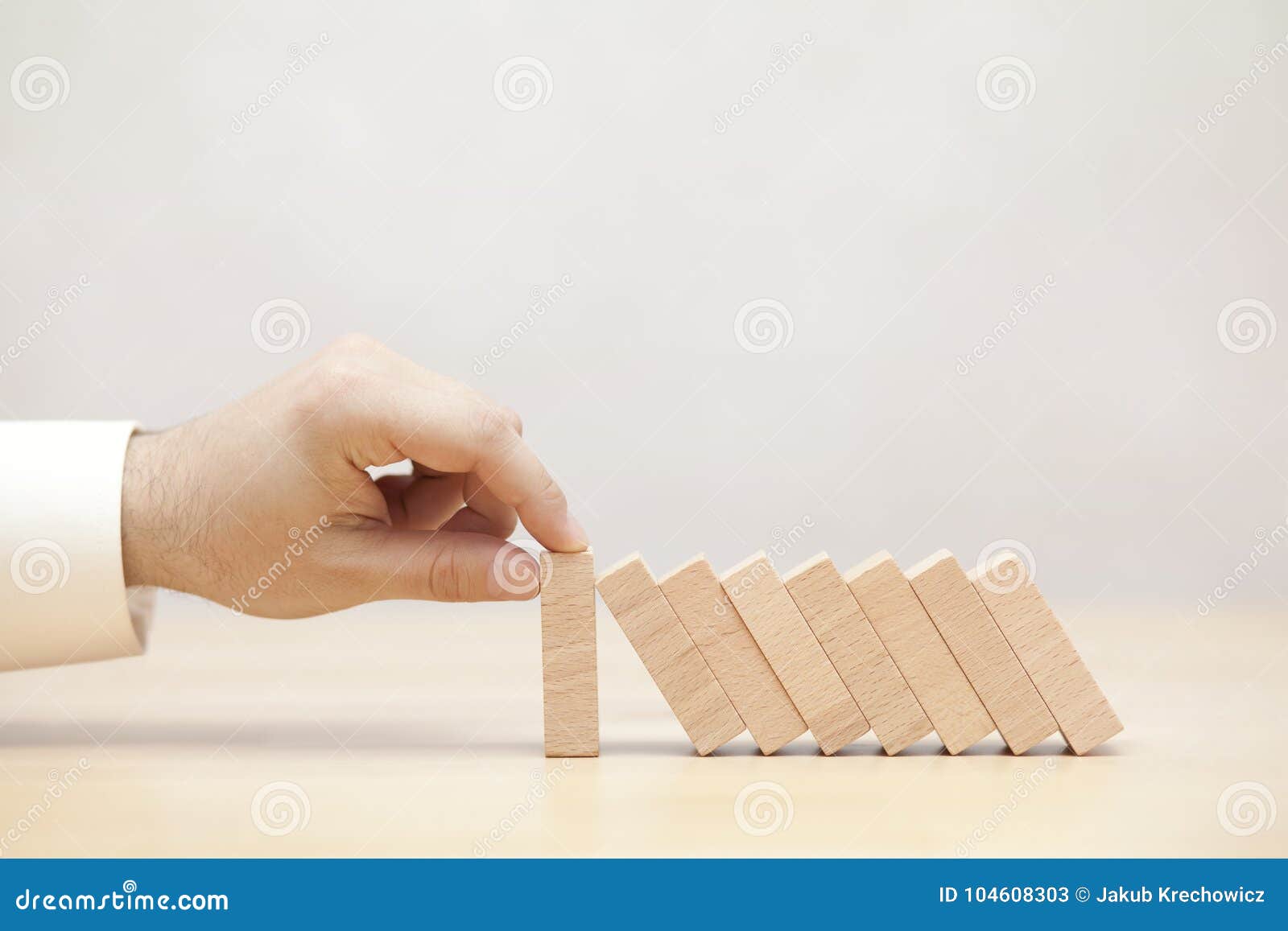 Man`s Hand Stopping the Domino Effect Stock Image - Image of domino ...