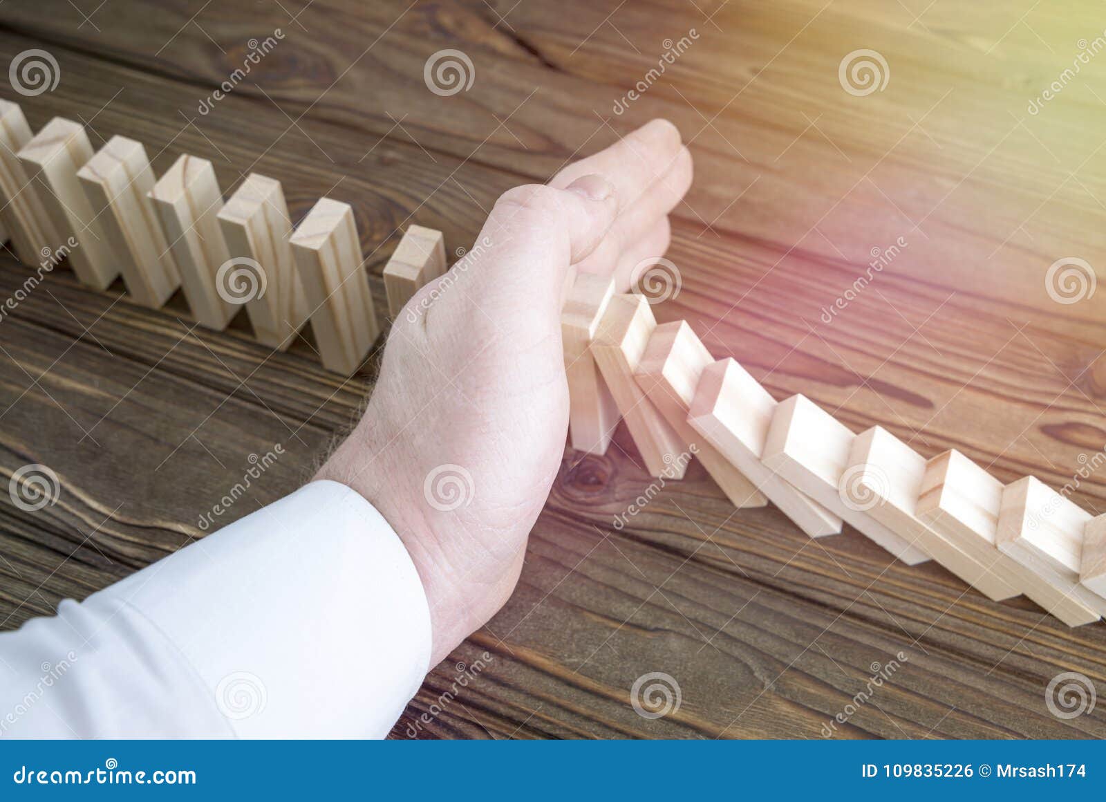 The Man`s Hand Stops the Domino Effect. Stock Photo - Image of ...