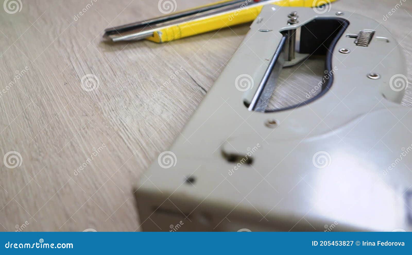 A Man`s Hand Takes a Stapler from the Table. Old Tools are on the Table ...