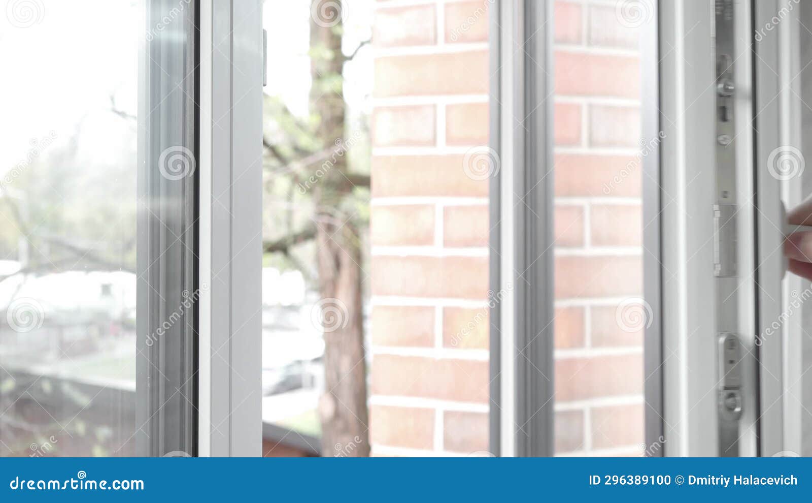 A Man S Hand Turns the Handle of the Window Frame and Opens the Plastic ...