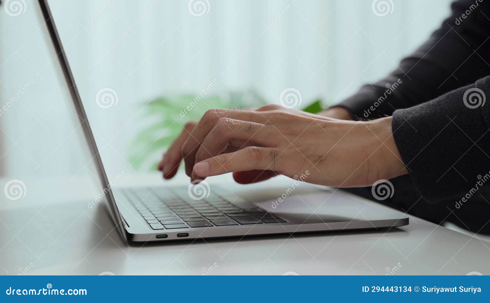 The Man S Hand is Typing on a Laptop Computer Keyboard at Home or in ...