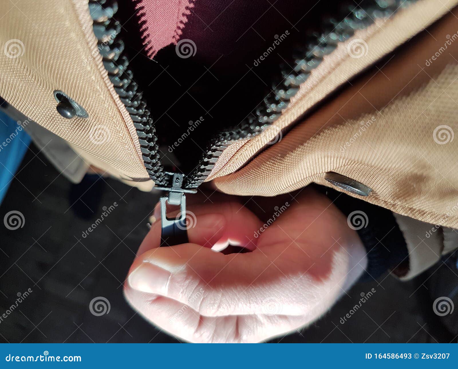 The Man`s Hand Zips Zip Up on the Jacket. Zipper Close Up in Hard Light ...