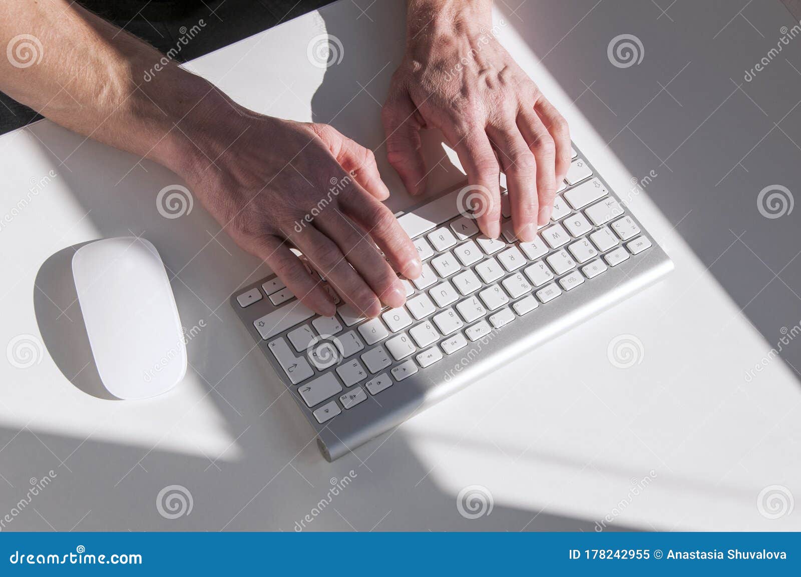 Man`s Hands on a Computer Keyboard and Mouse. Workspace Lighted by Sun ...