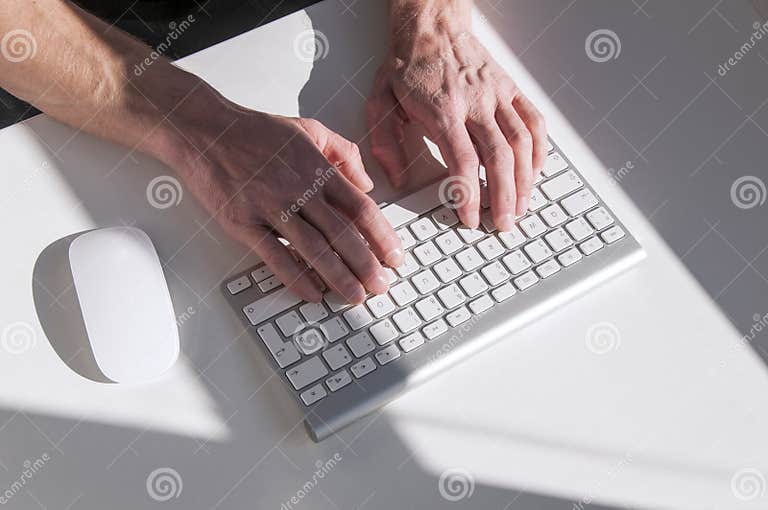Man`s Hands on a Computer Keyboard and Mouse. Workspace Lighted by Sun ...
