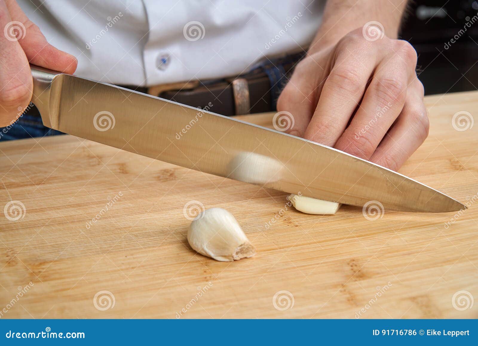 Man`s Hands Cutting Fresh Garlic in the Kitchen, Preparing a Meal for ...