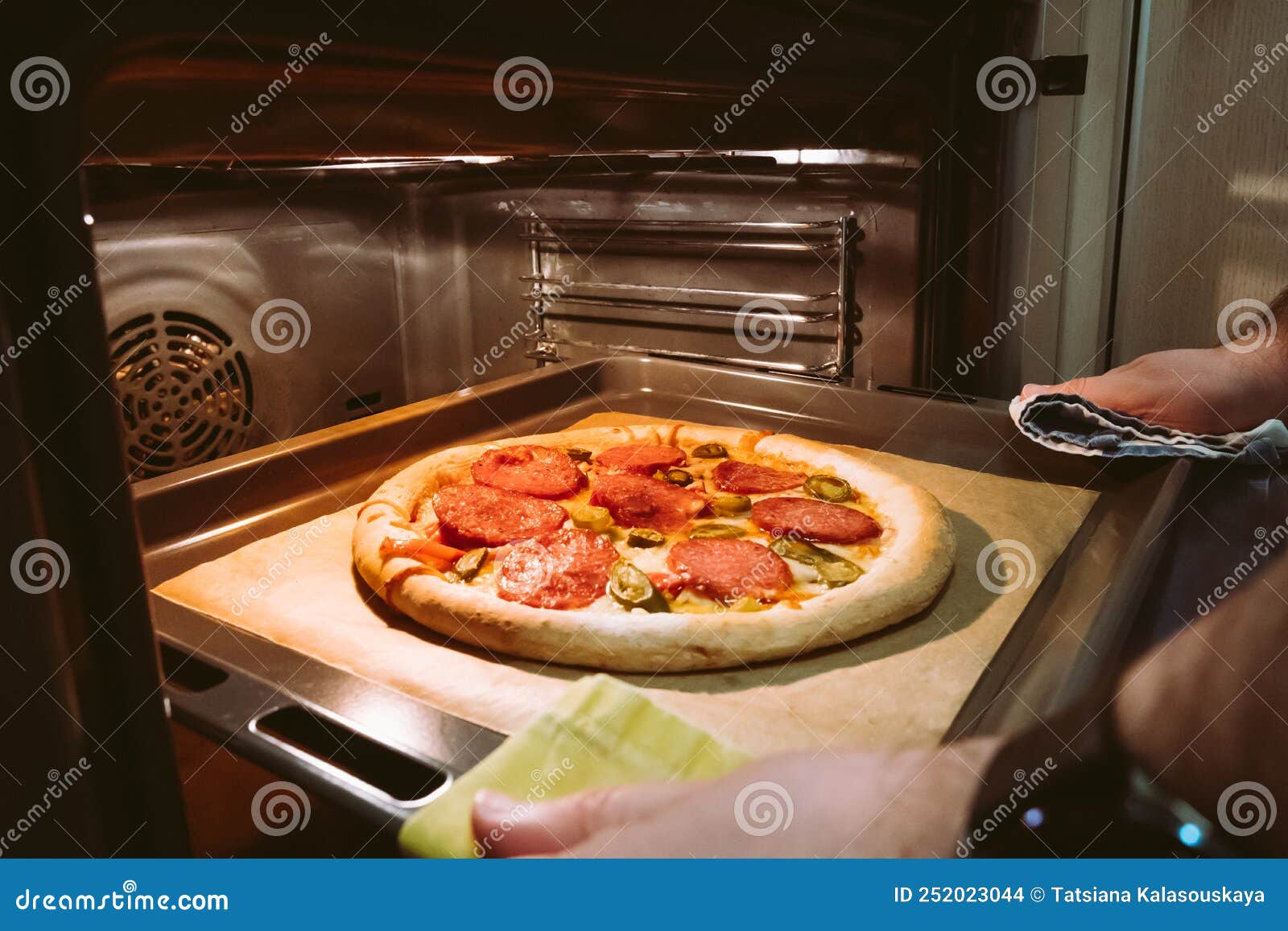 A Man& X27;s Hands Pull Out a Homemade Pepperoni Pizza from the Oven ...