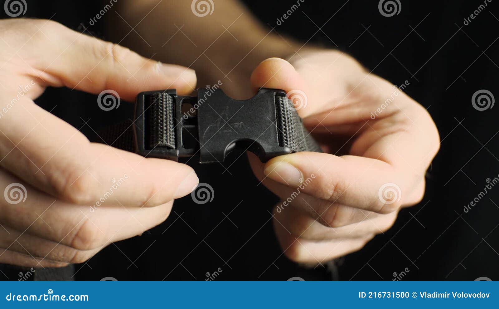 The Man`s Hands Unfasten the Black Plastic Fastener on His Belt Stock ...
