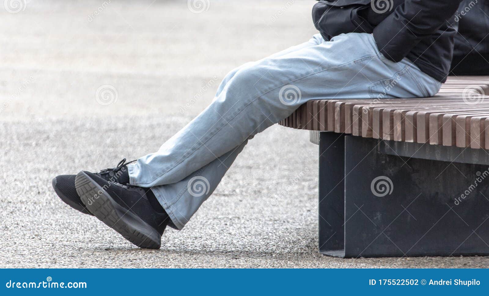 Man`s legs on a park bench stock photo. Image of grass - 175522502