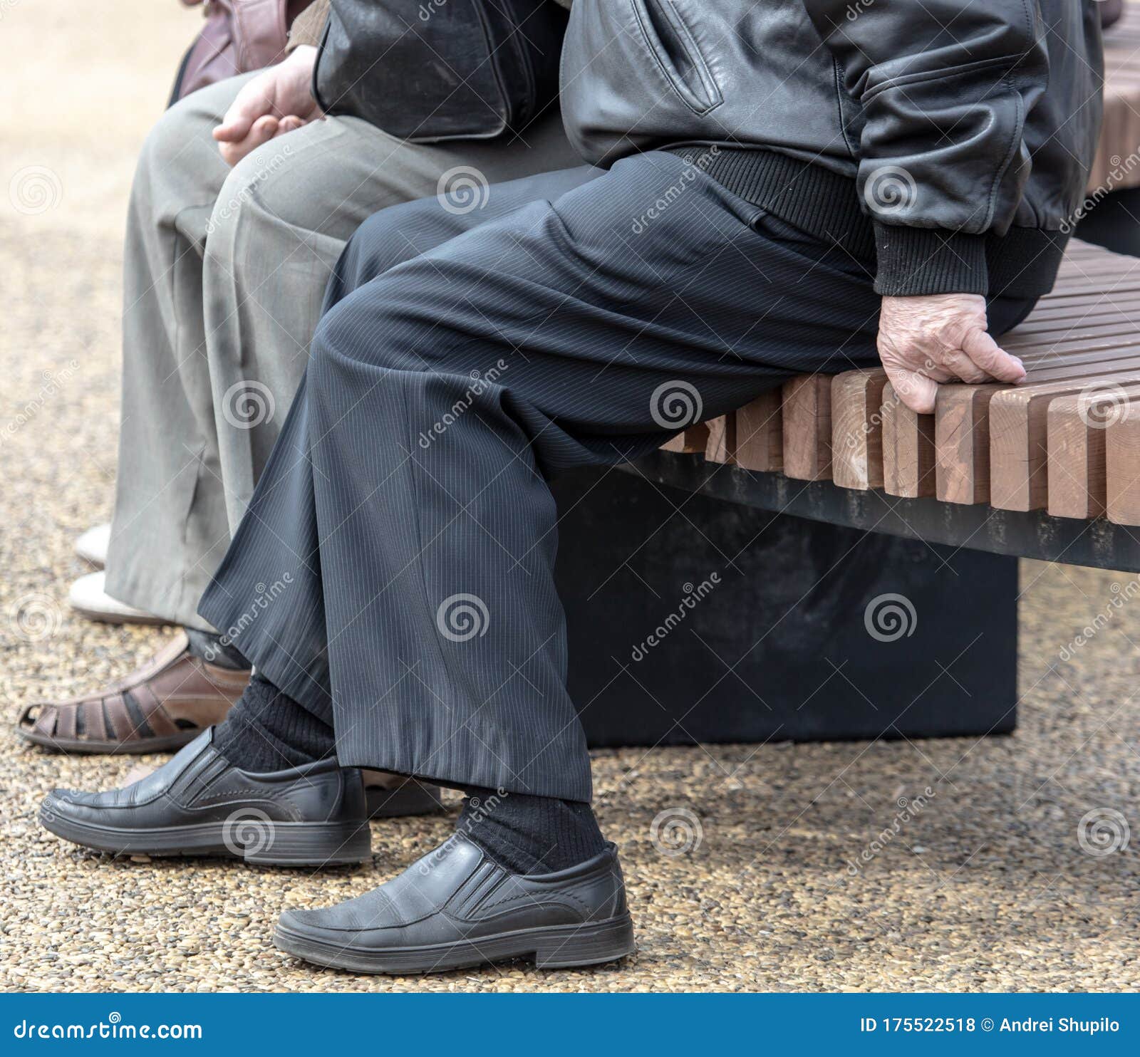 Man`s legs on a park bench stock photo. Image of nature - 175522518