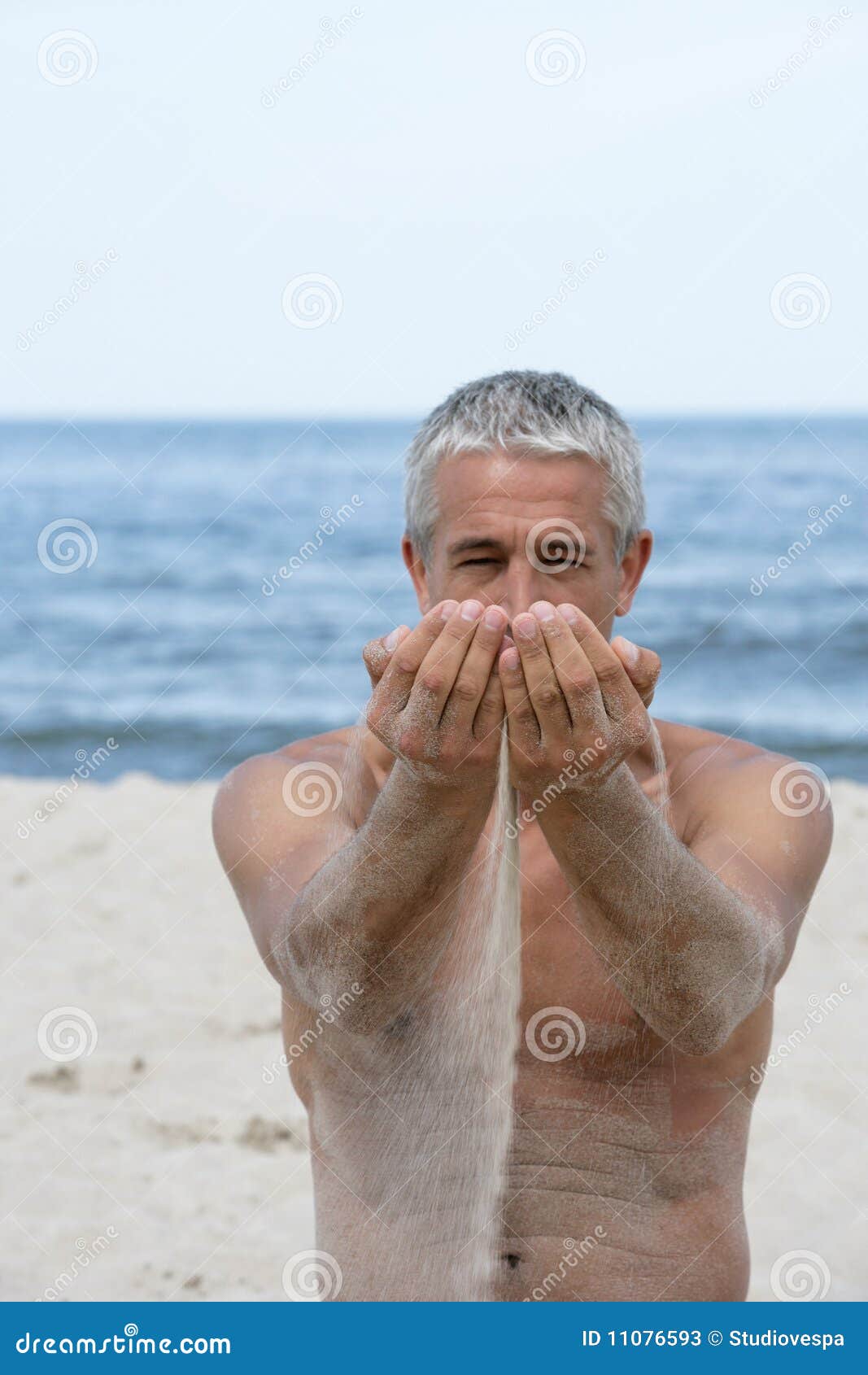 Man with sand in hands stock image. Image of handsome - 11076593
