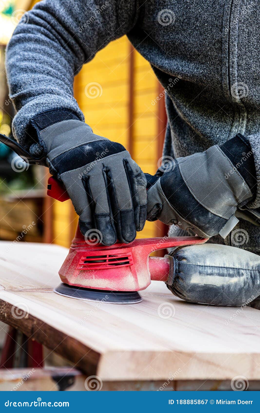 Man is Sanding with an Disk Type Sander or Orbital Sander a Wooden ...