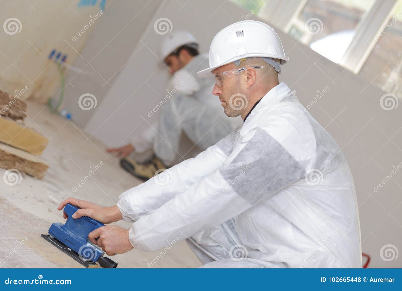 Man sanding surface floor stock photo. Image of sander - 102665448