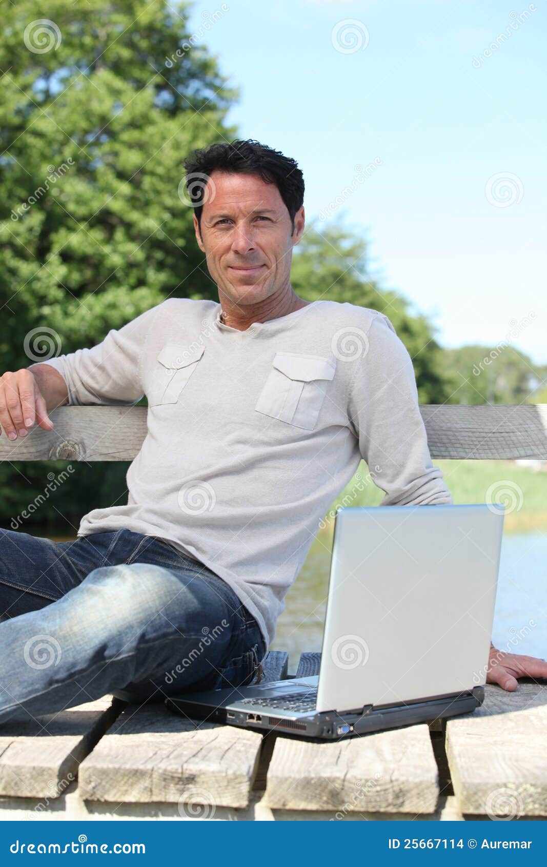 Man sat on park bench stock photo. Image of field, laptop - 25667114