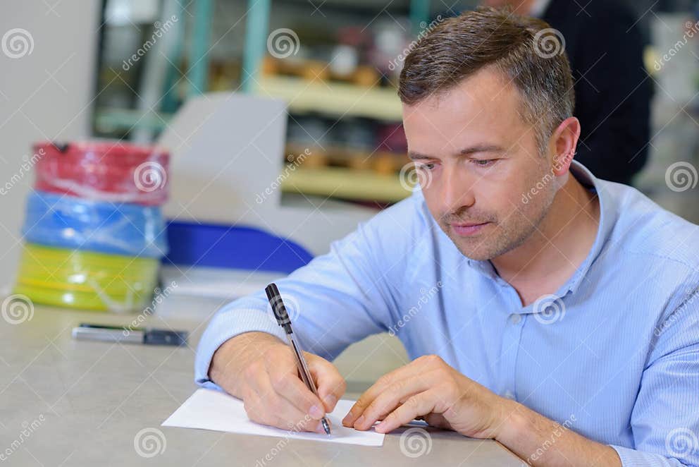 Man sat at table writing stock image. Image of reel - 302959697