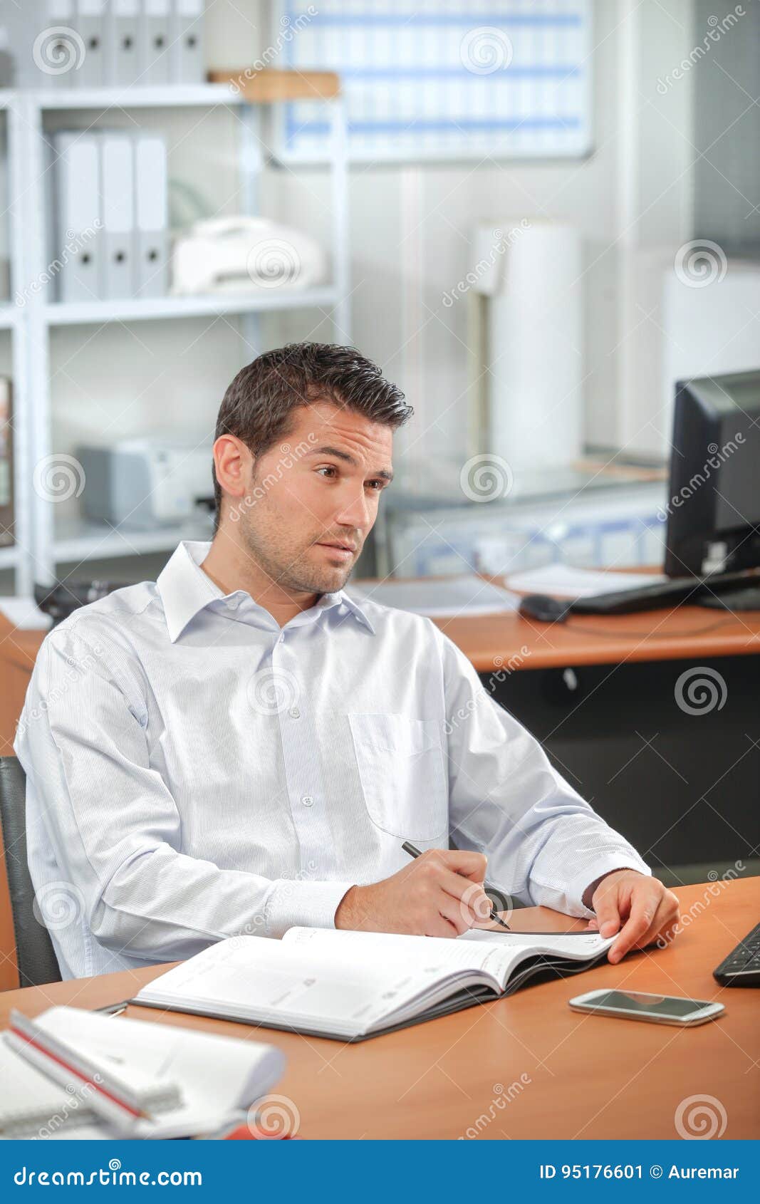 Man sat writing at desk stock image. Image of business - 95176601