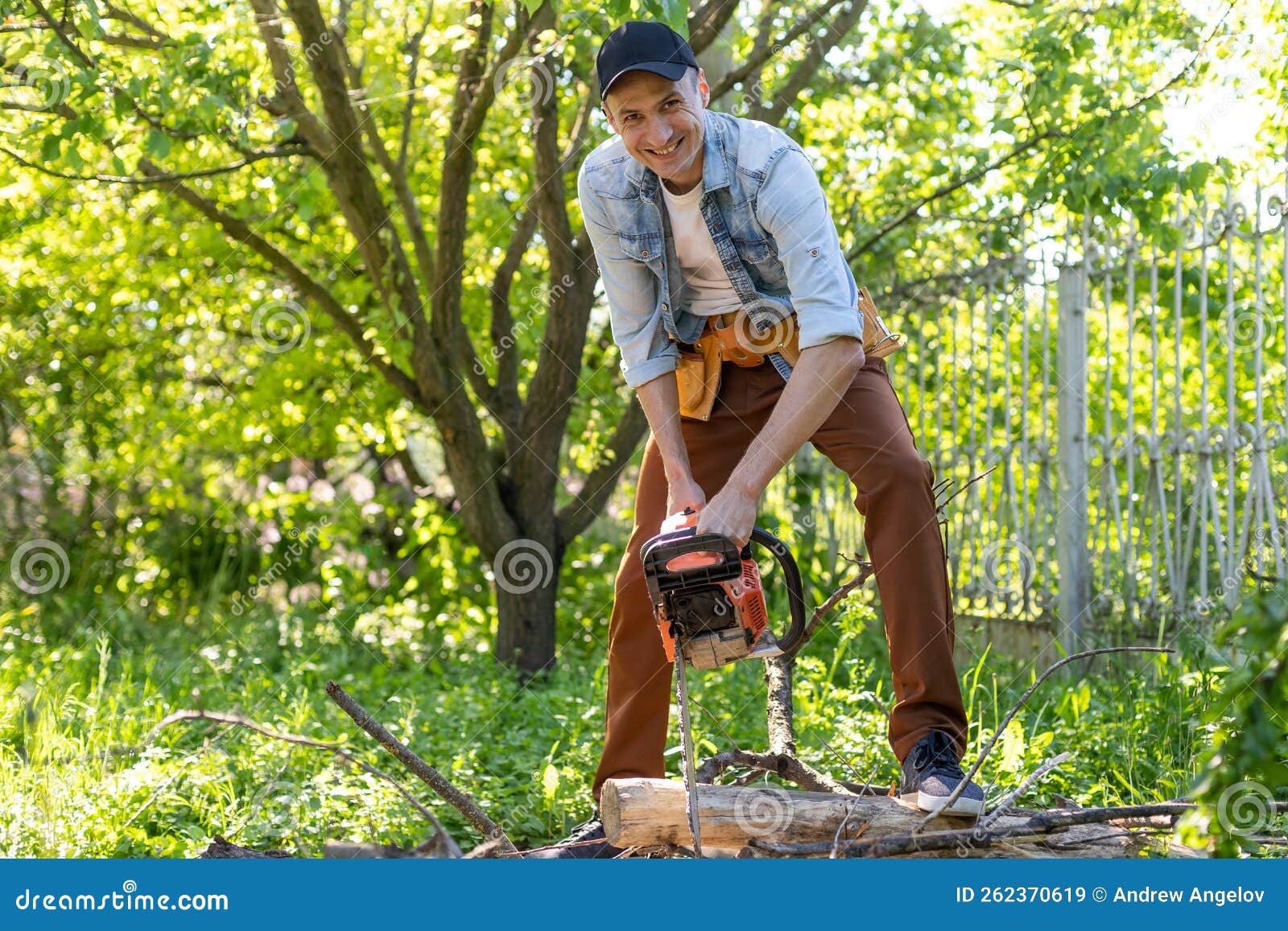 Man Sawing Branches with a Chainsaw. Concept of a Professional Logging ...