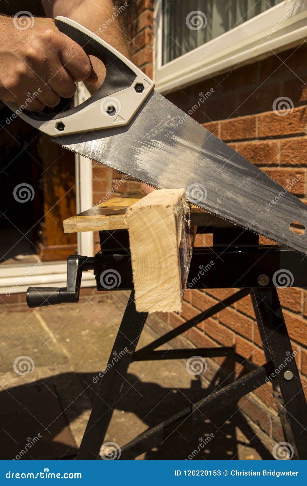 Man Sawing Wood Outside Using a Hand Saw Stock Image - Image of ...