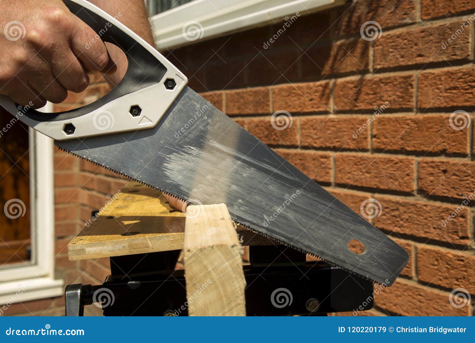 Man Sawing Wood Outside Using a Hand Saw Stock Image - Image of ...