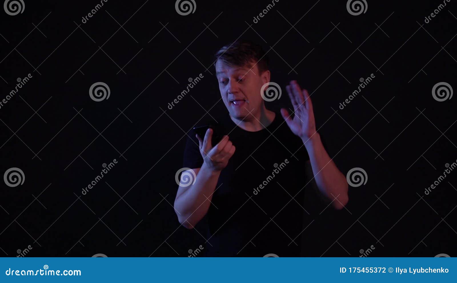 The Man Says Bye Bye Goodbye on the Phone and Runs on Black Background ...