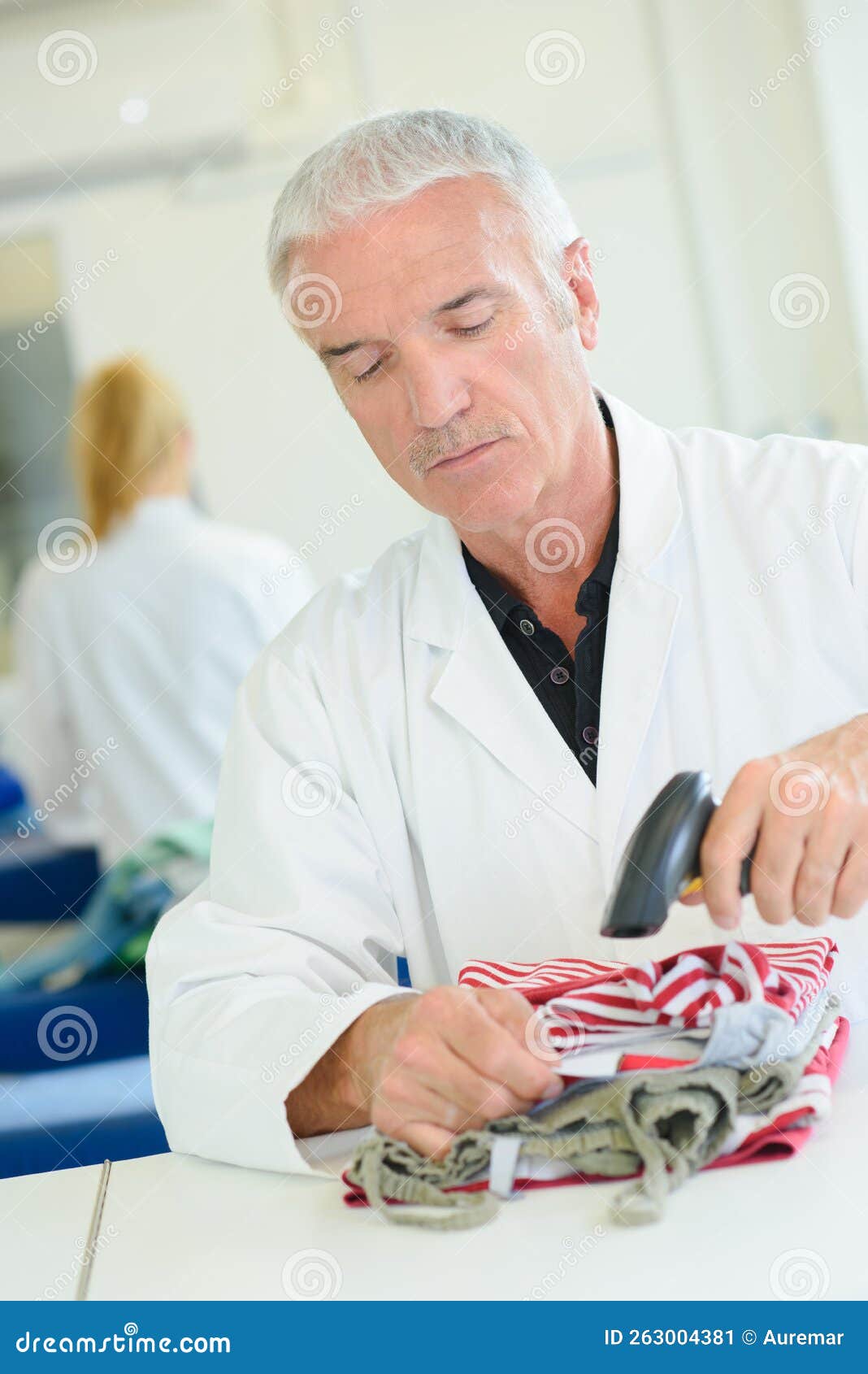 Man scanning garment stock image. Image of reader, white - 263004381