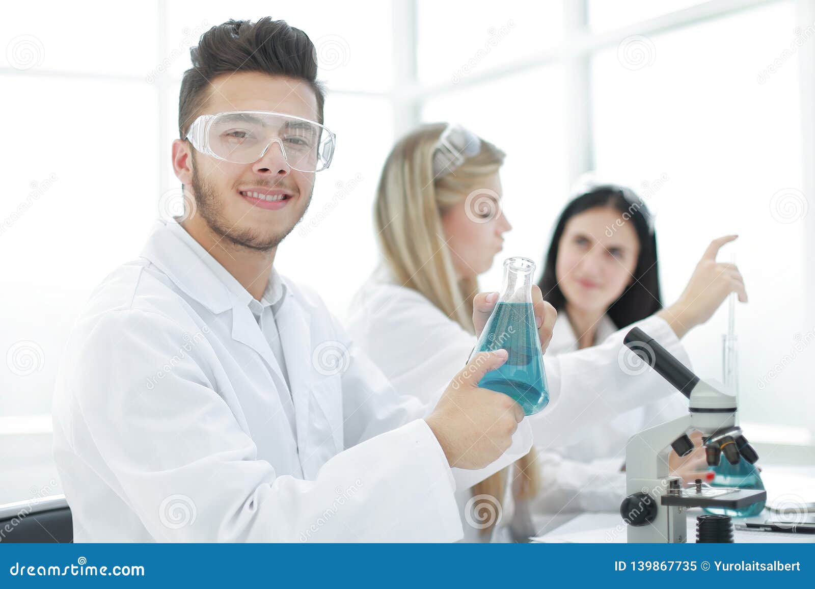Man Scientist Holding a Flask of Liquid for the Experiment Stock Image ...