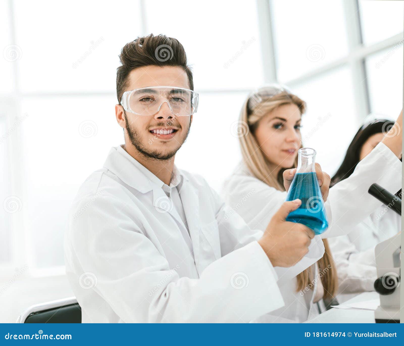 Man Scientist Holding a Flask of Liquid for the Experiment Stock Photo ... Man Scientist Holding a Flask of Liquid for the Experiment Stock Photo ...