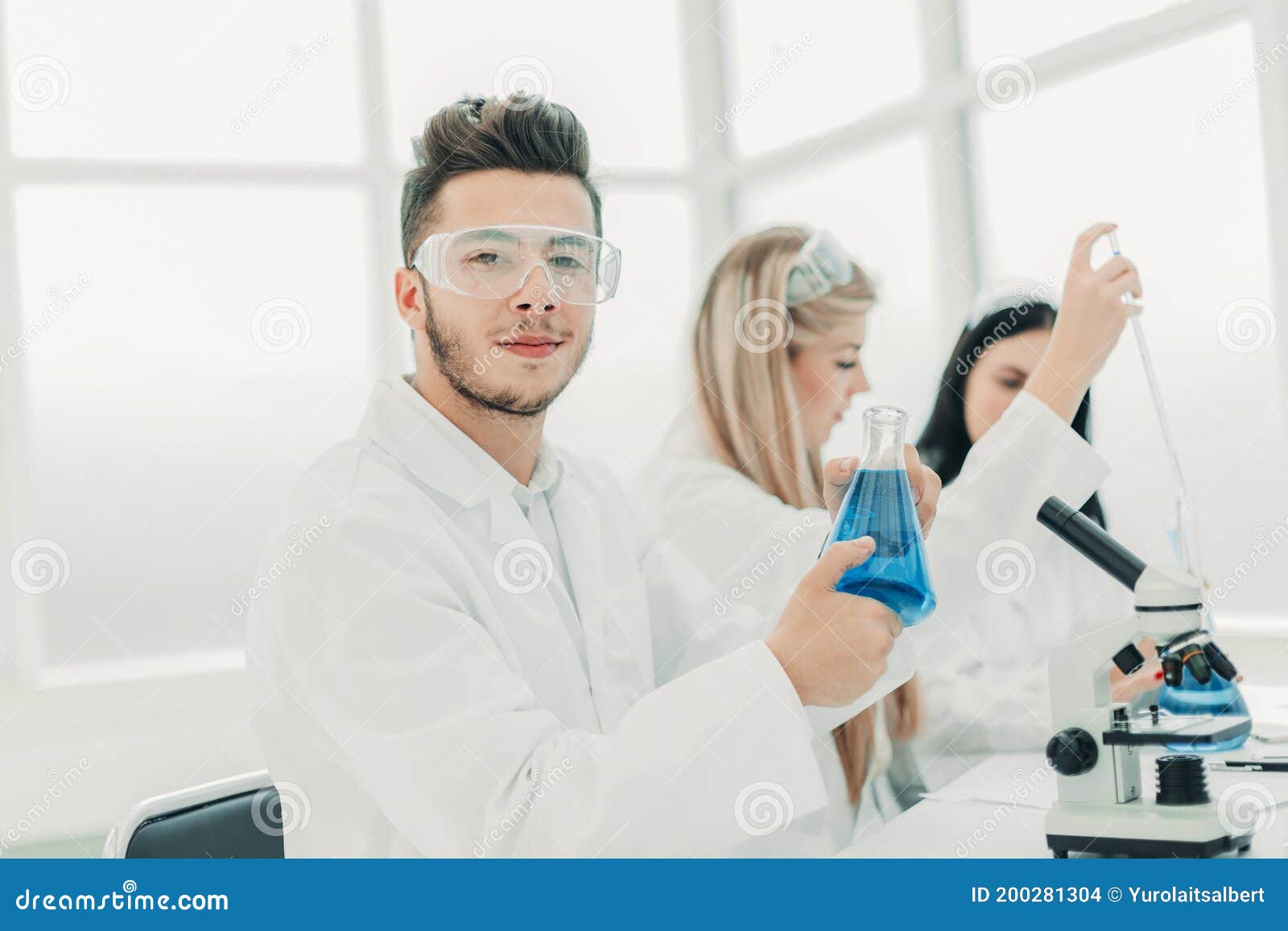 Man Scientist Holding a Flask of Liquid for the Experiment Stock Photo ...