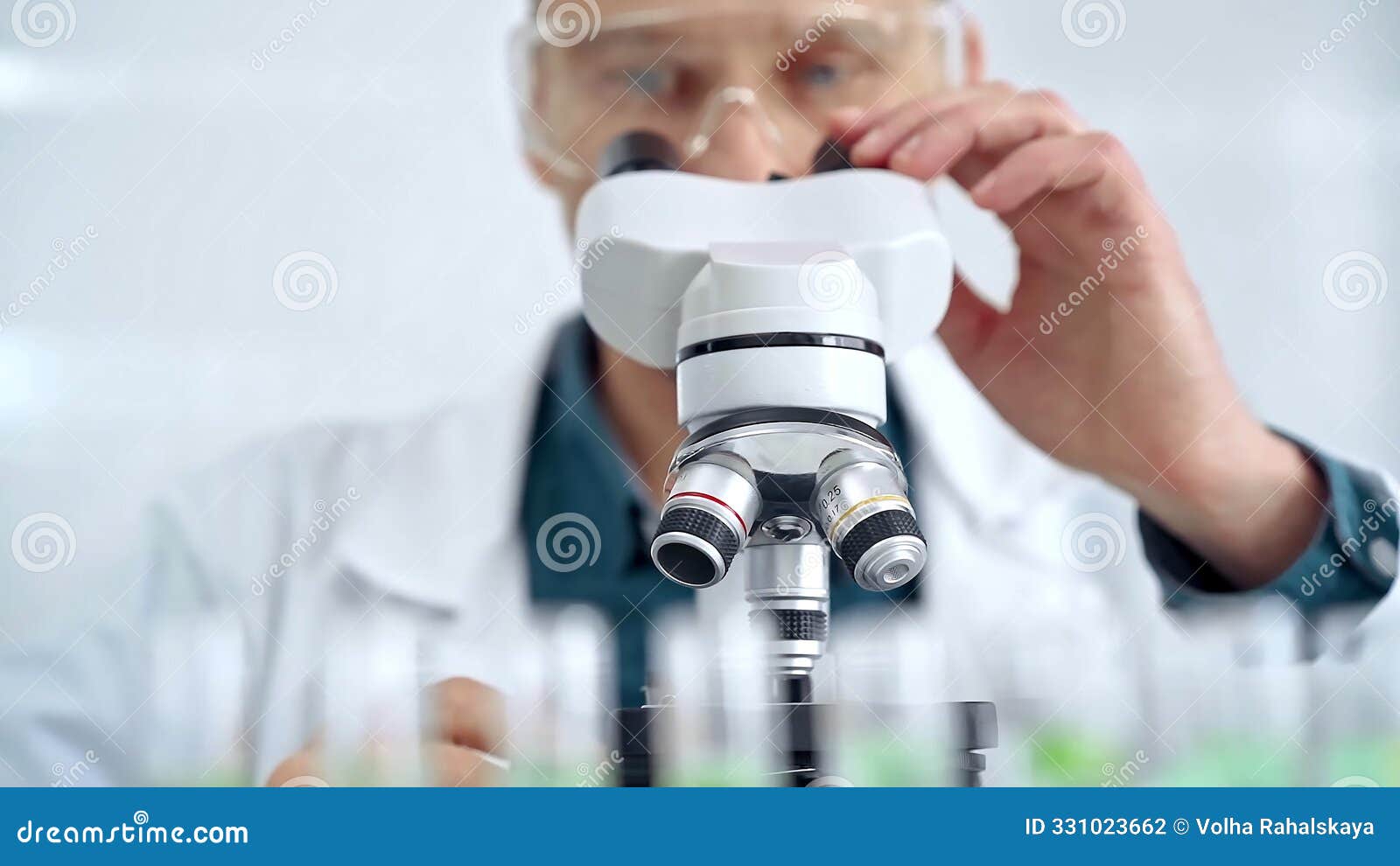 Man Scientist with Protective Glasses Using Microscope in Laboratory ...