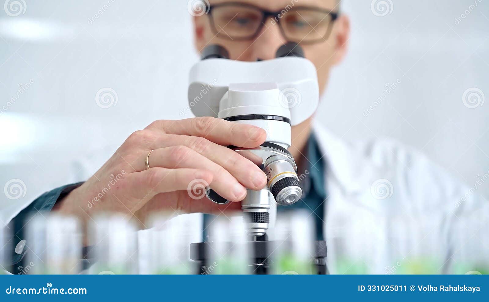 Man Scientist with Protective Glasses Using Microscope in Laboratory ...