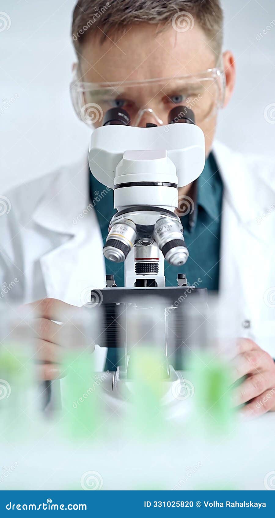 Man Scientist with Protective Glasses Using Microscope in Laboratory ...