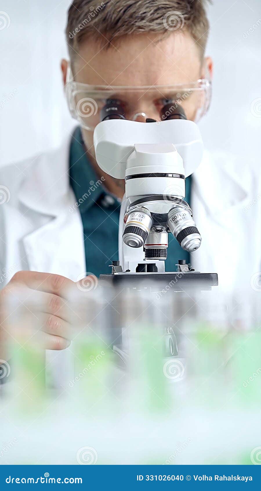 Man Scientist with Protective Glasses Using Microscope in Laboratory ...