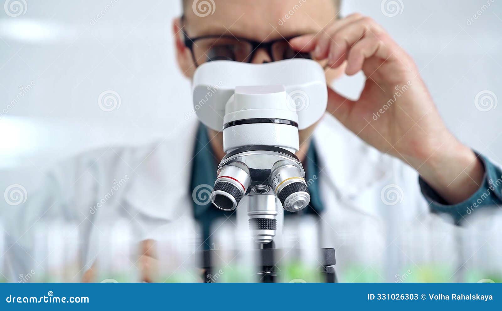 Man Scientist with Protective Glasses Using Microscope in Laboratory ...
