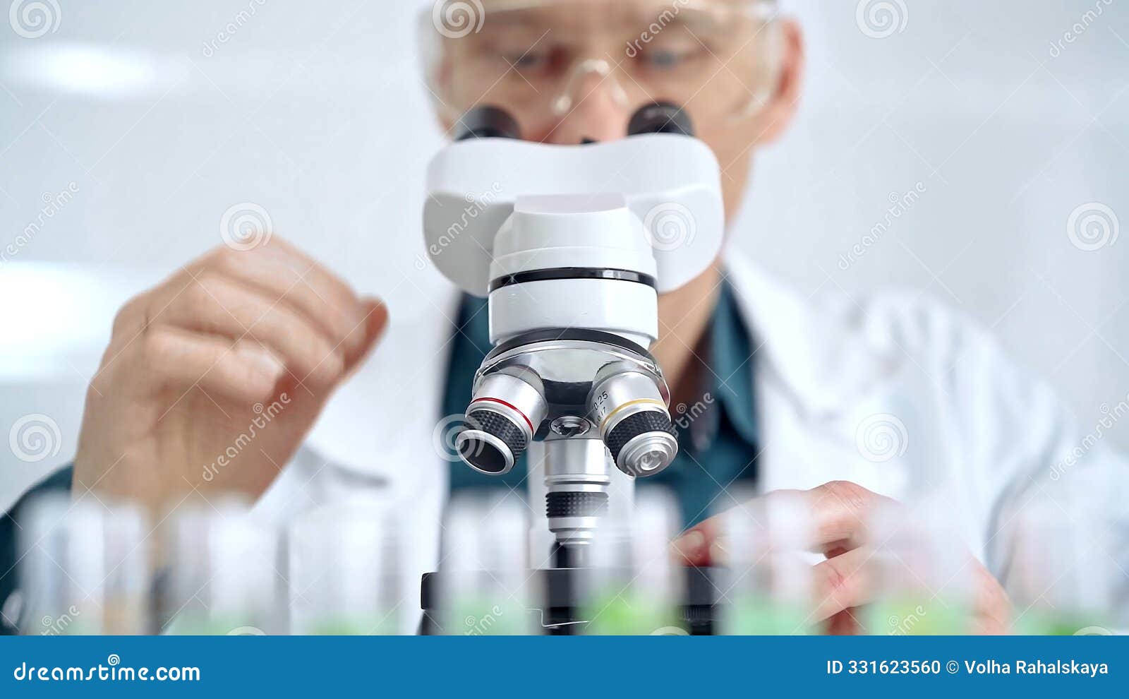Man Scientist with Protective Glasses Using Microscope in Laboratory ...
