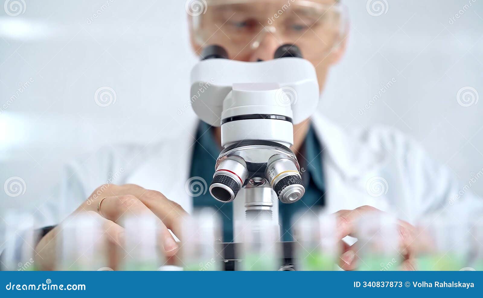 Man Scientist with Protective Glasses Using Microscope in Laboratory ...