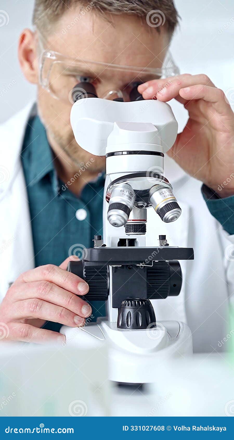 Man Scientist with Protective Glasses Using Microscope in Laboratory ...